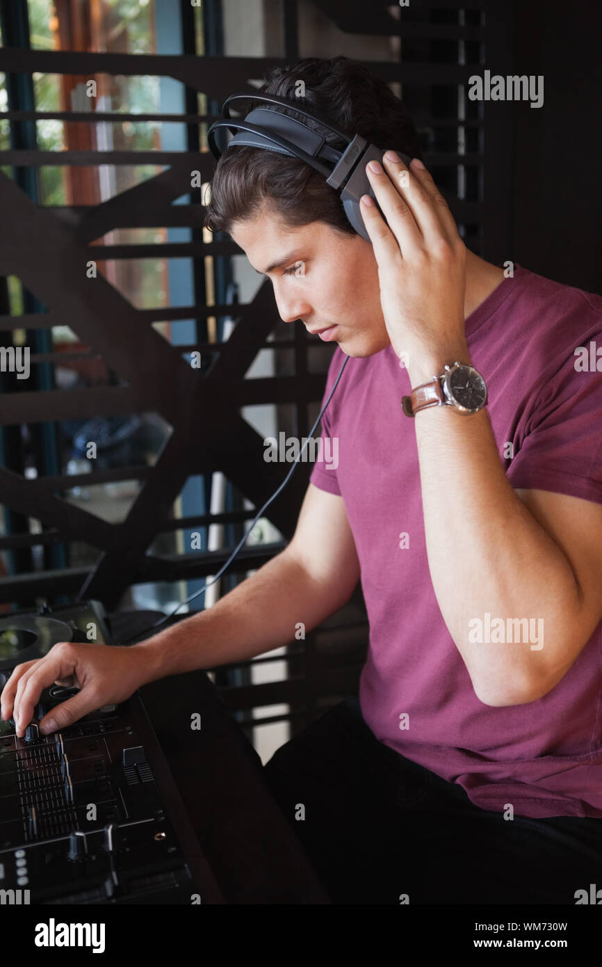 Cool dj working on a sound mixing desk at the nightclub Stock Photo - Alamy