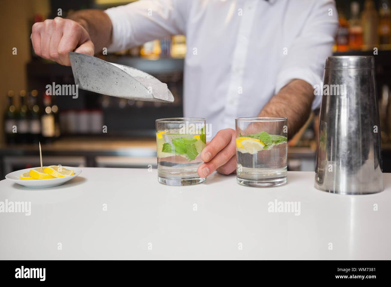 Happy bartender making a cocktail in a bar Stock Photo - Alamy