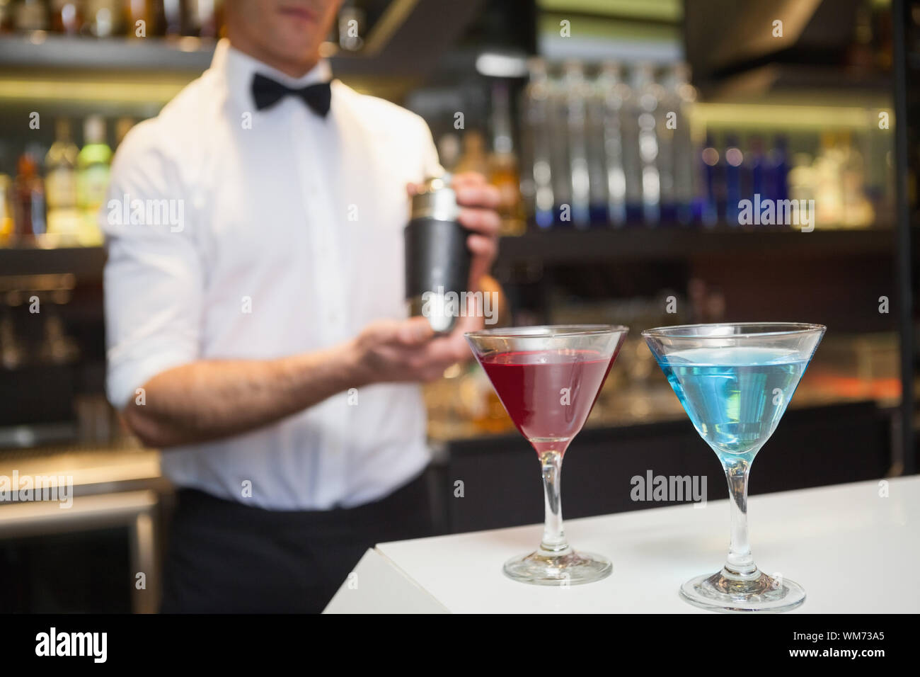 Attractive bar man making a cocktail in a bar Stock Photo - Alamy