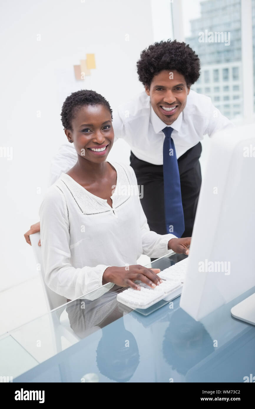 Happy business colleagues using computer in the office Stock Photo - Alamy