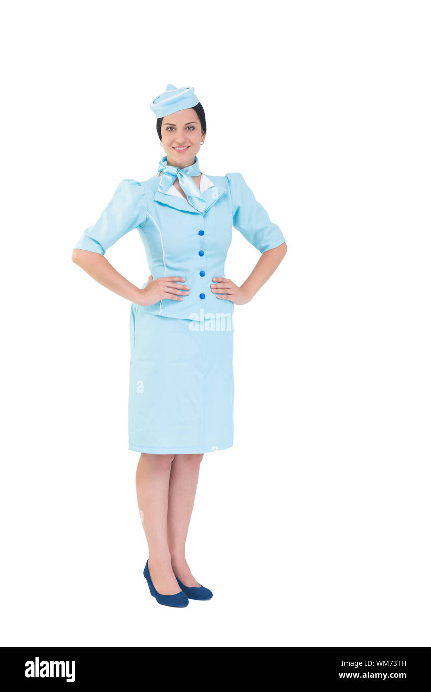 Pretty air hostess smiling at camera on white background Stock Photo ...