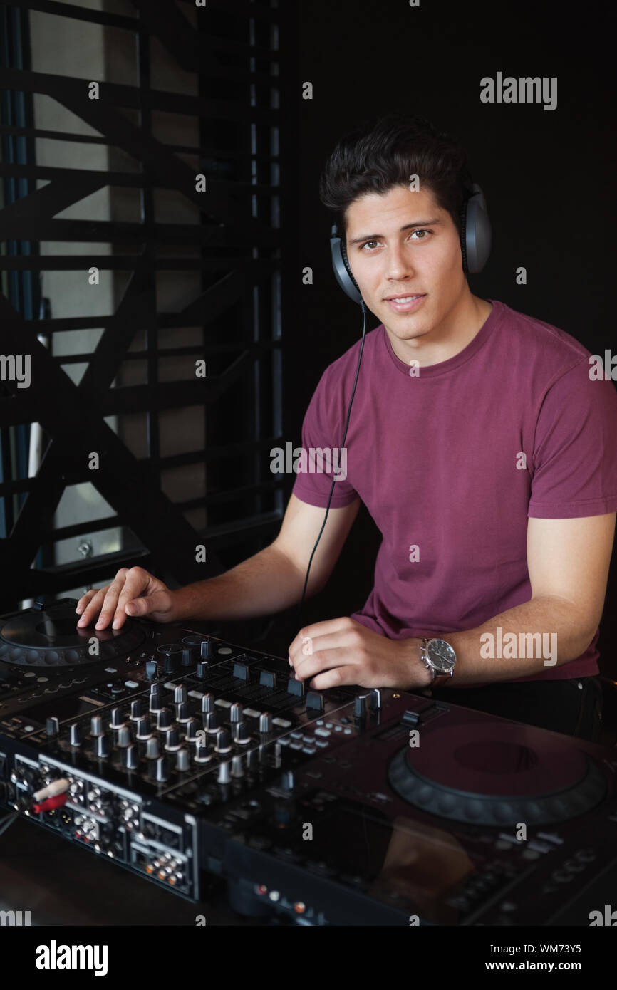 Cool dj working on a sound mixing desk at the nightclub Stock Photo - Alamy