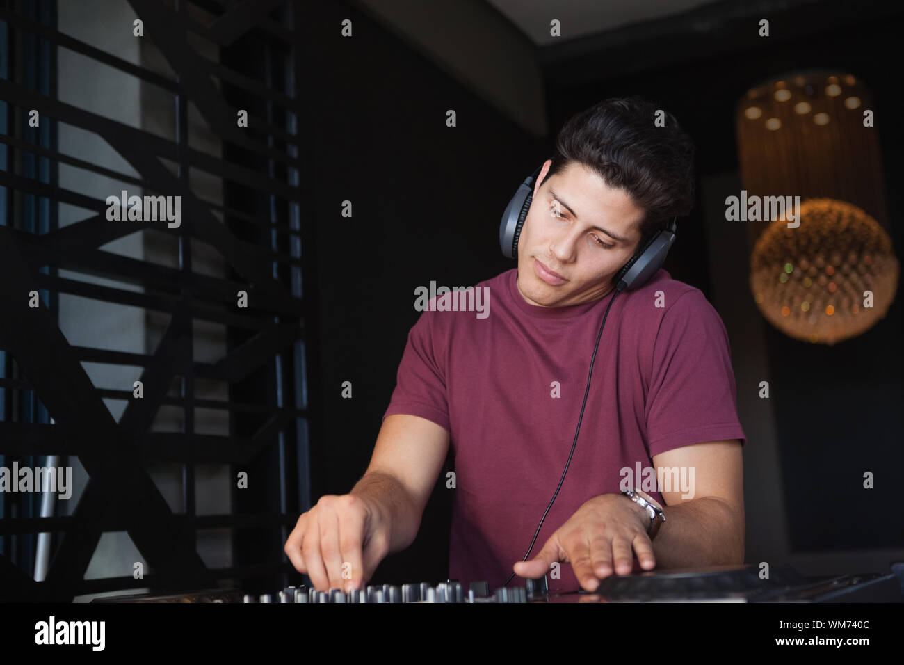 Cool dj working on a sound mixing desk at the nightclub Stock Photo - Alamy