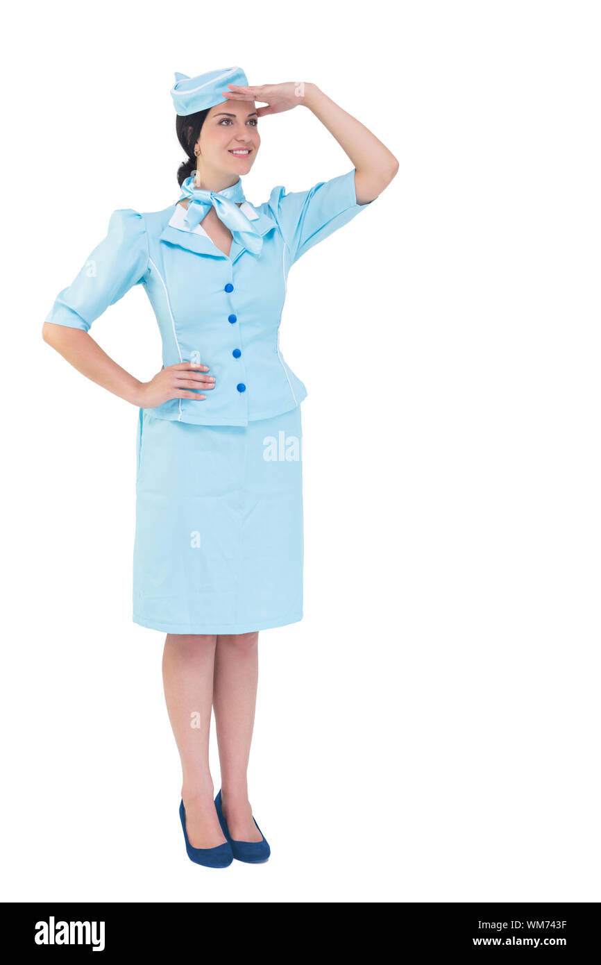 Pretty air hostess with hand on hip on white background Stock Photo - Alamy