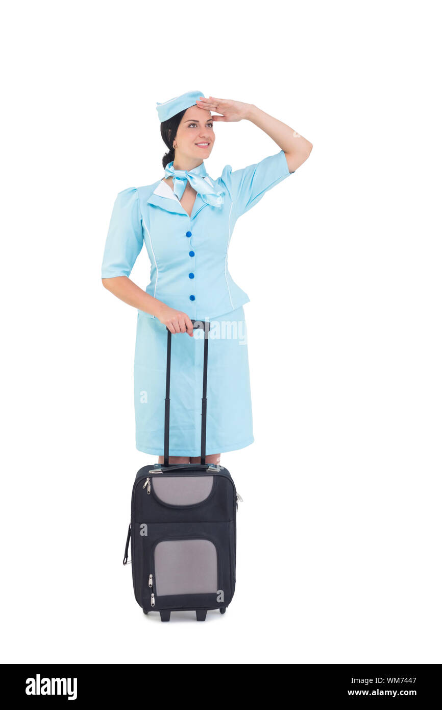 Pretty air hostess holding suitcase on white background Stock Photo - Alamy