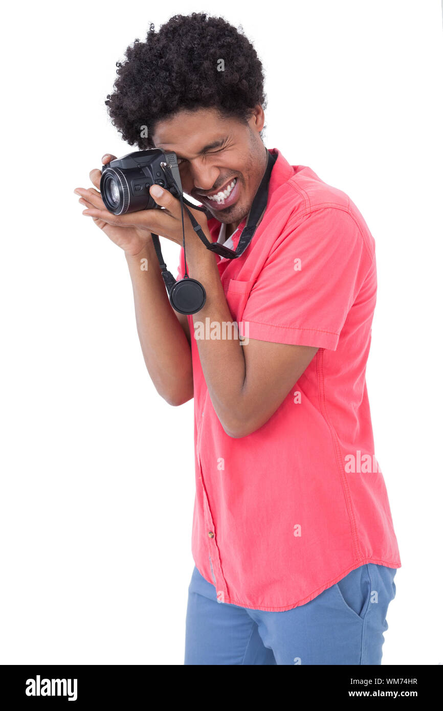 Happy man taking photograph with digital camera on white background ...