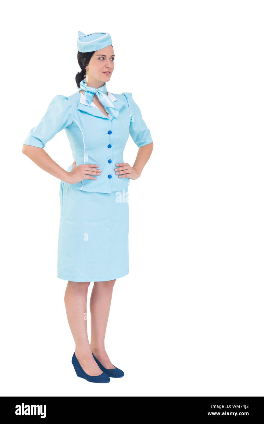 Pretty air hostess with hands on hips on white background Stock Photo ...