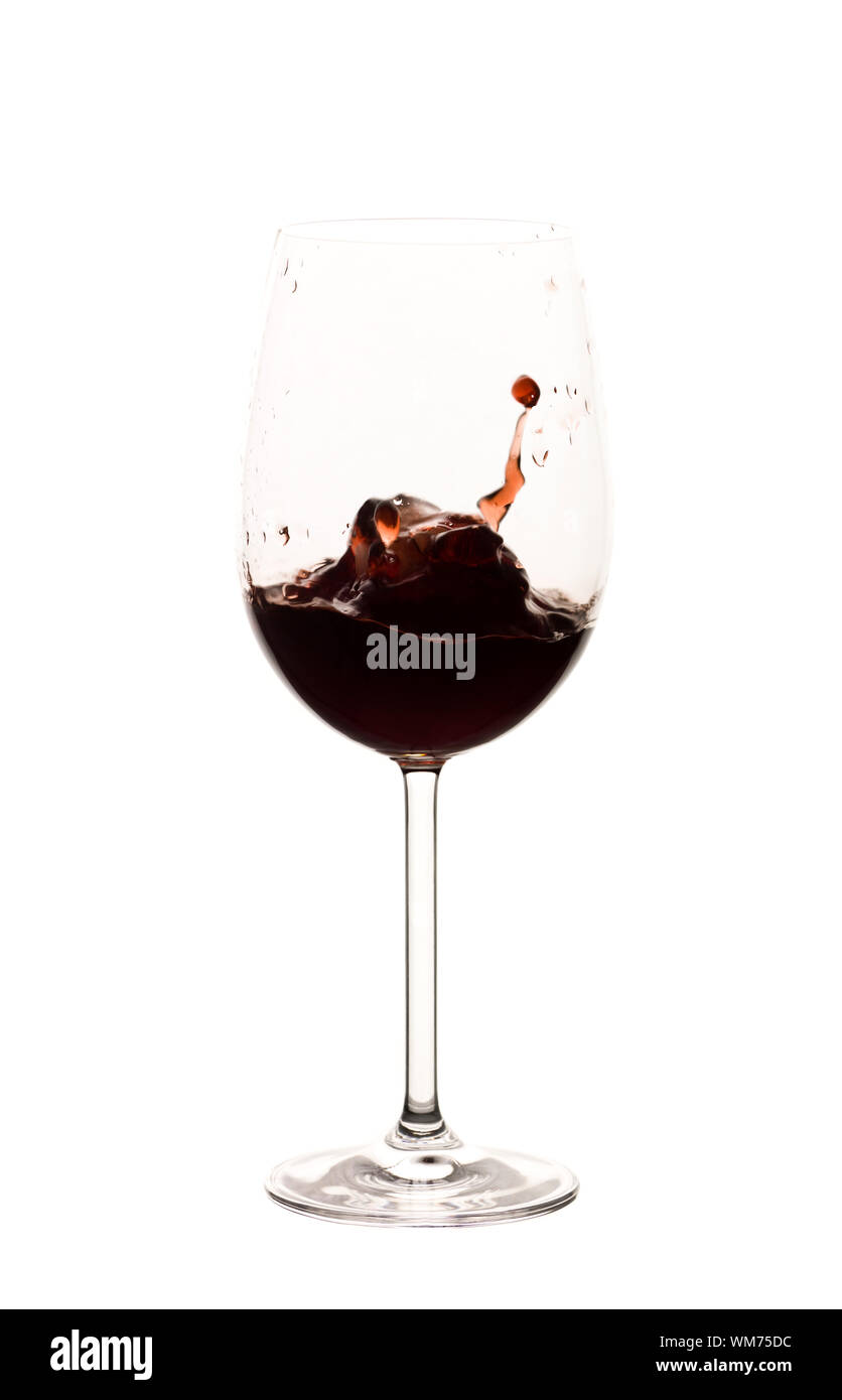 Red wine splashing in glass Stock Photo - Alamy
