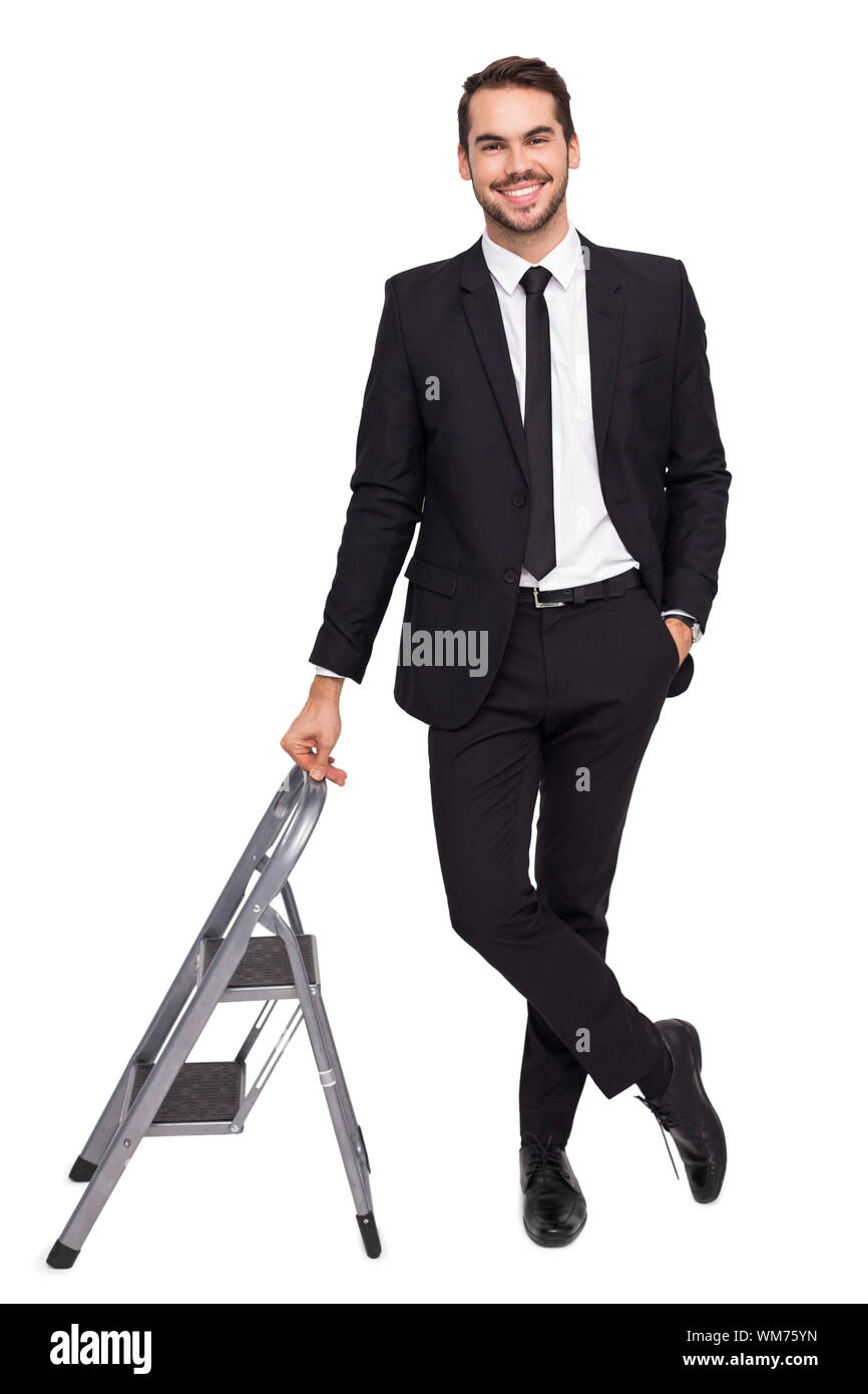 Smiling businessman leaning on stepladder on white background Stock ...