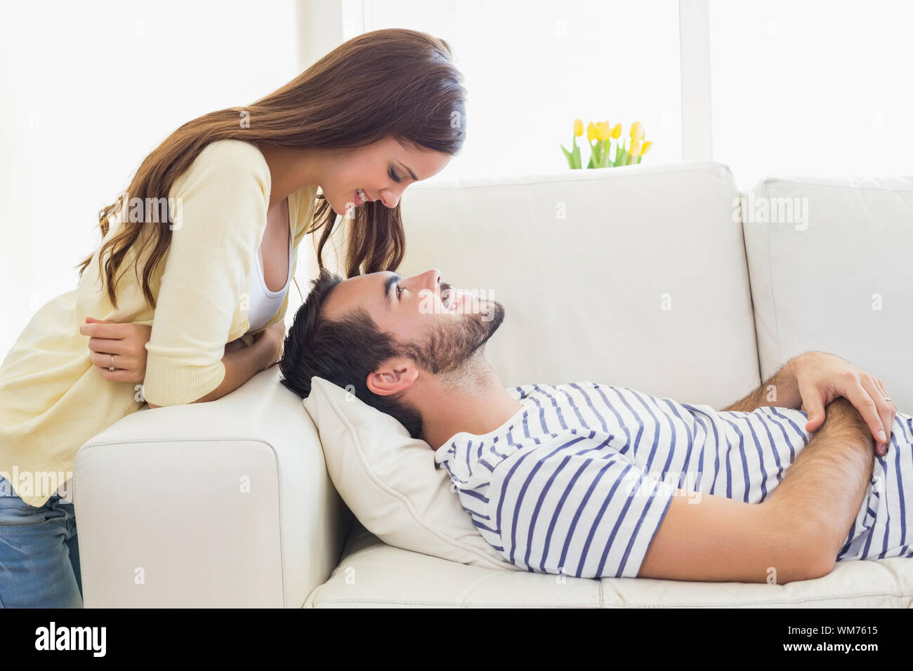 Cute couple relaxing on couch at home in the living room Stock Photo ...