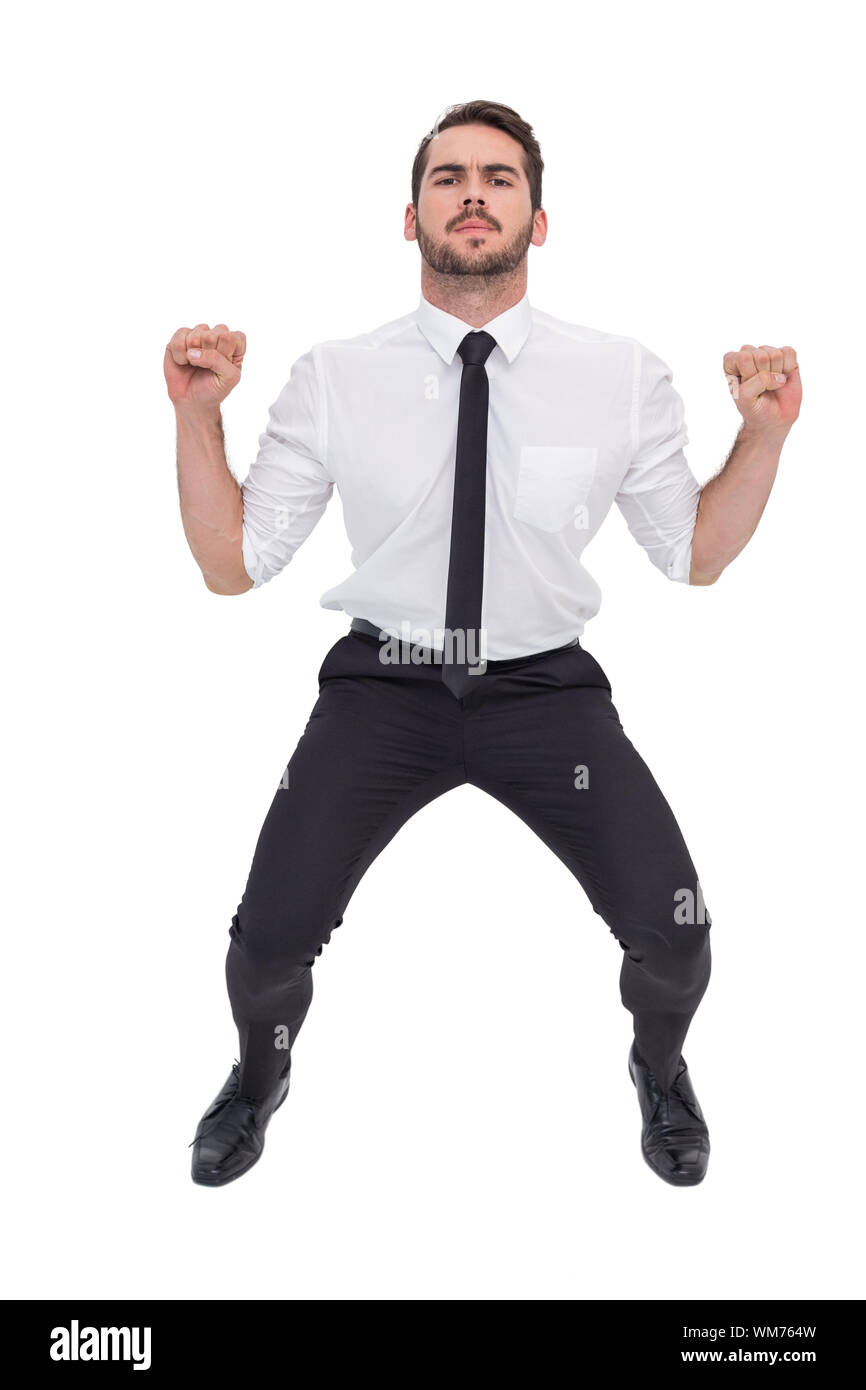 Focused businessman lifting up something heavy on white background ...