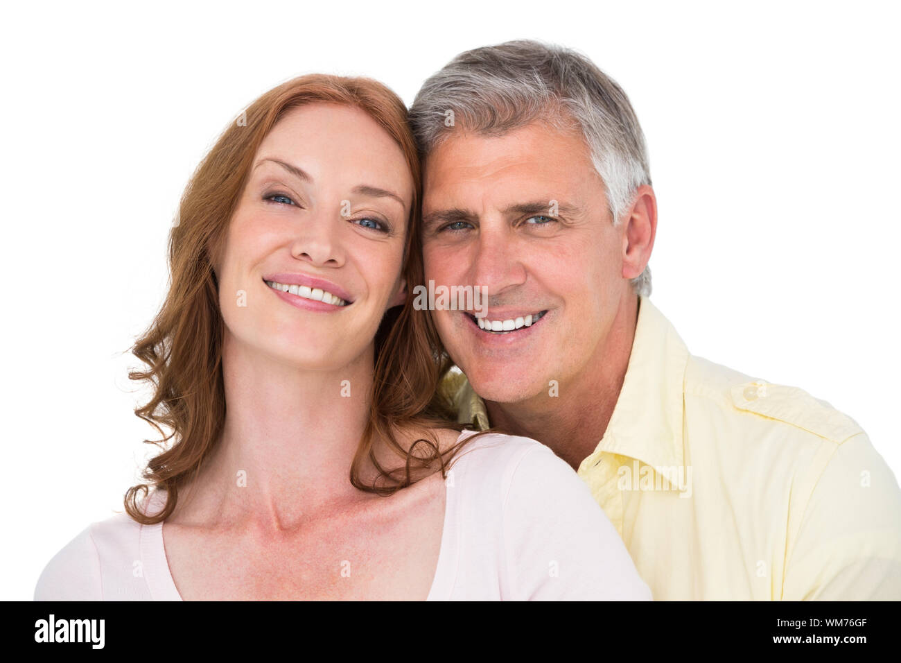 Casual couple hugging and smiling on white background Stock Photo - Alamy