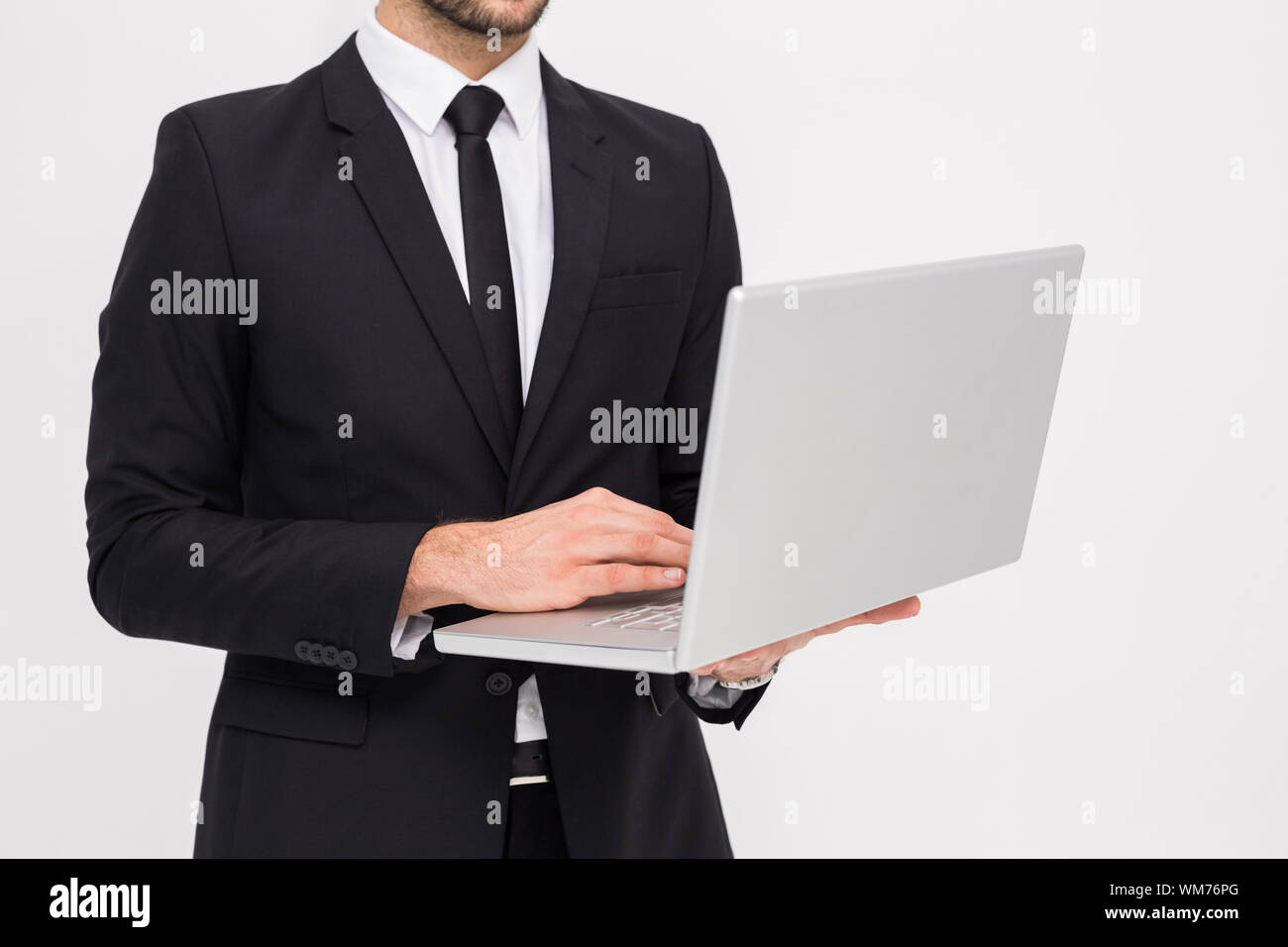 Mid section of a businessman using laptop on white background Stock ...
