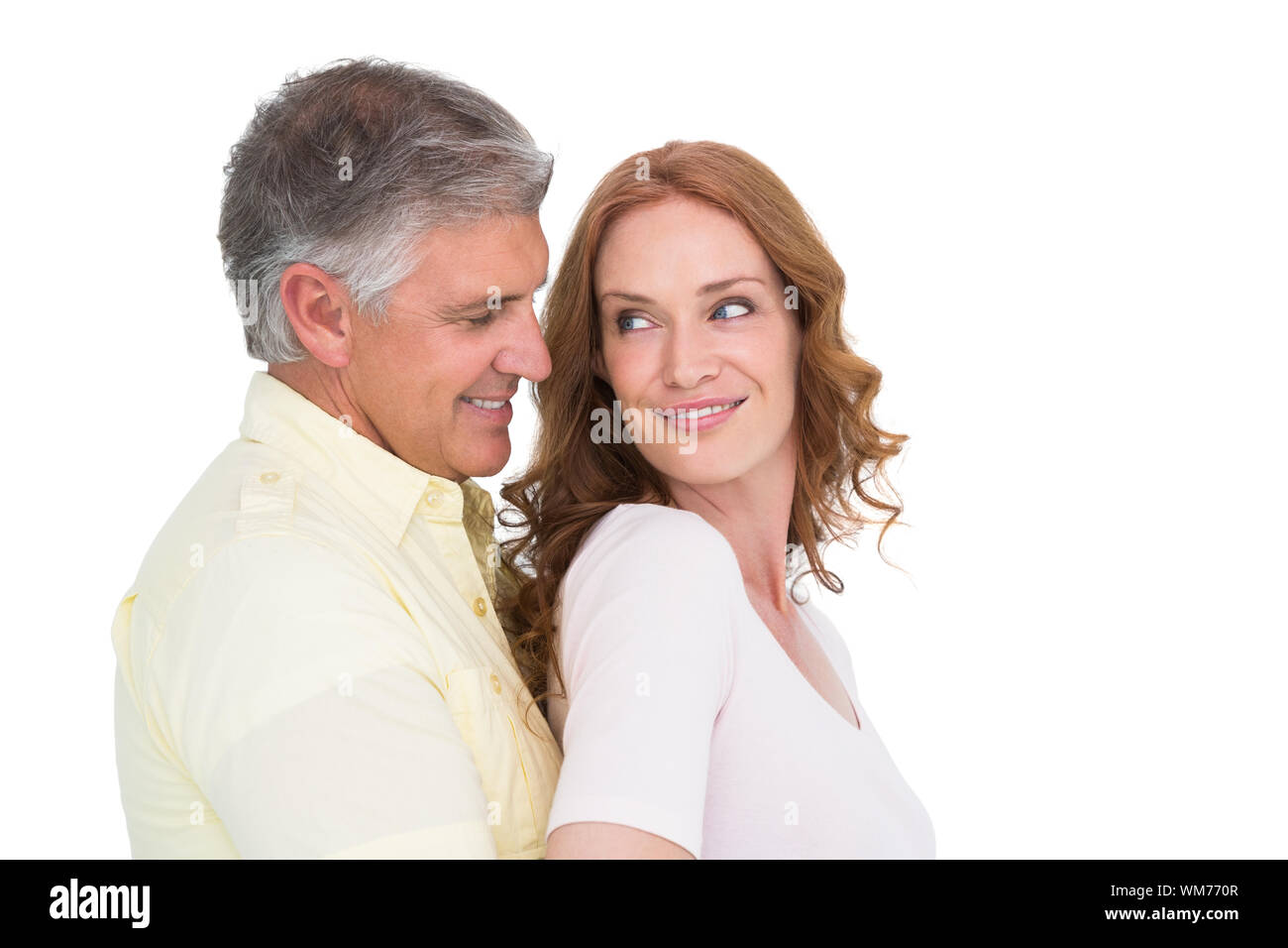 Casual couple hugging and smiling on white background Stock Photo - Alamy