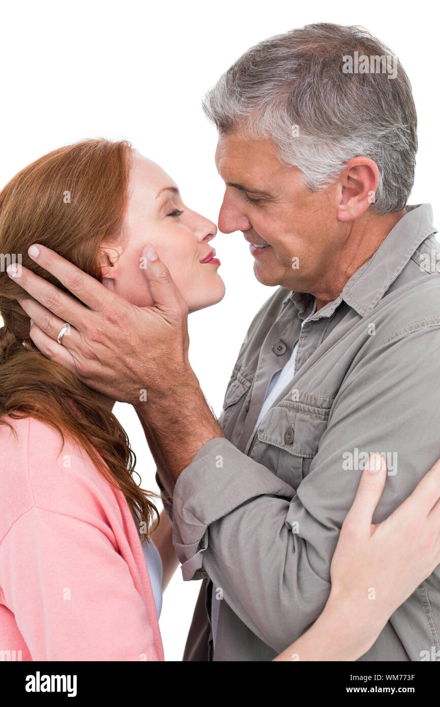 Casual couple hugging and smiling on white background Stock Photo - Alamy