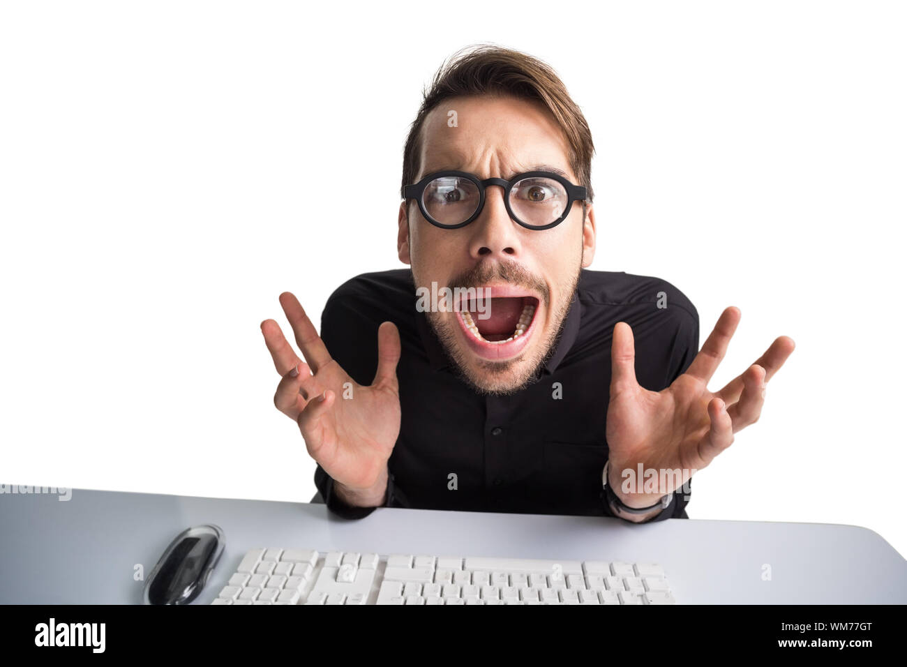 Worried businessman with glasses using computer on white background ...