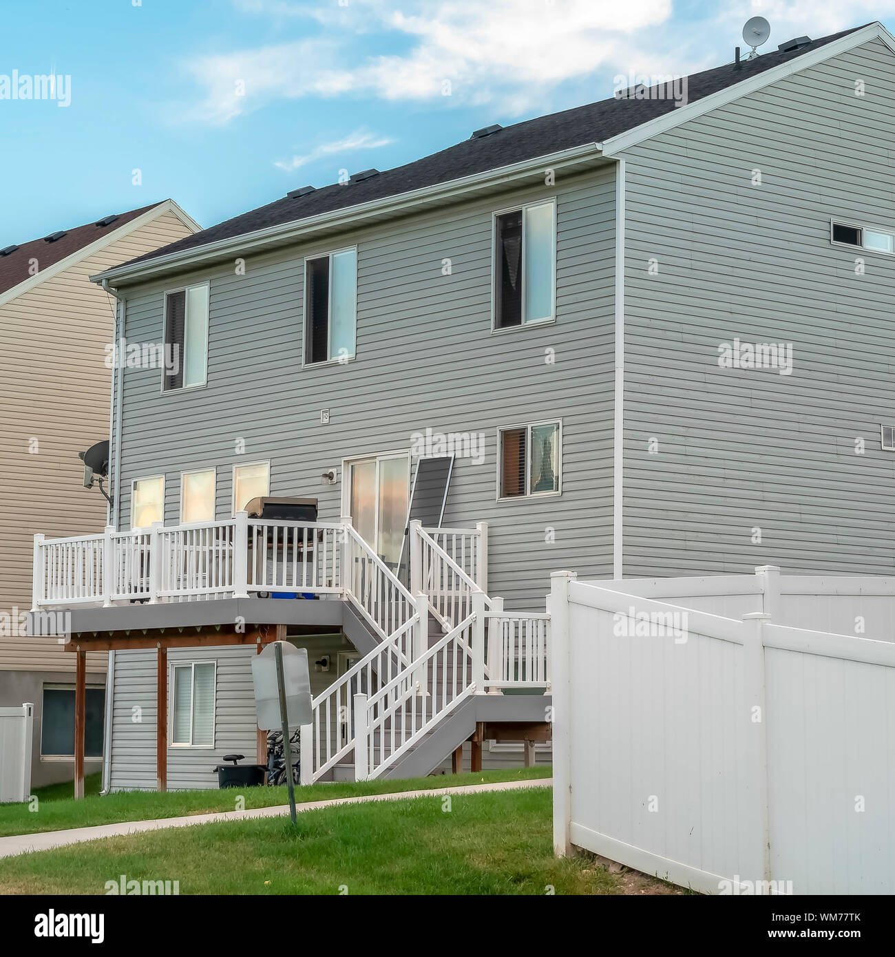 Square frame A house with gray horizontal wood siding and stairs that ...