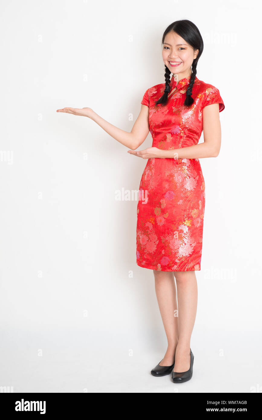 Portrait of full length Asian Chinese girl, hands showing something, in ...
