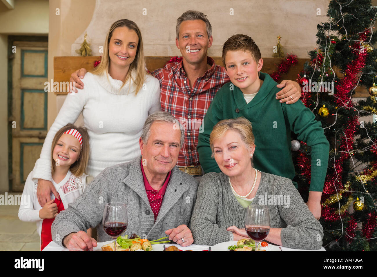 Happy extended family looking at camera at christmas time at home in ...