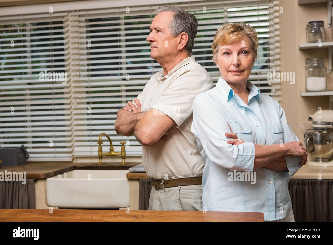 Senior couple having an argument at home in the kitchen Stock Photo - Alamy