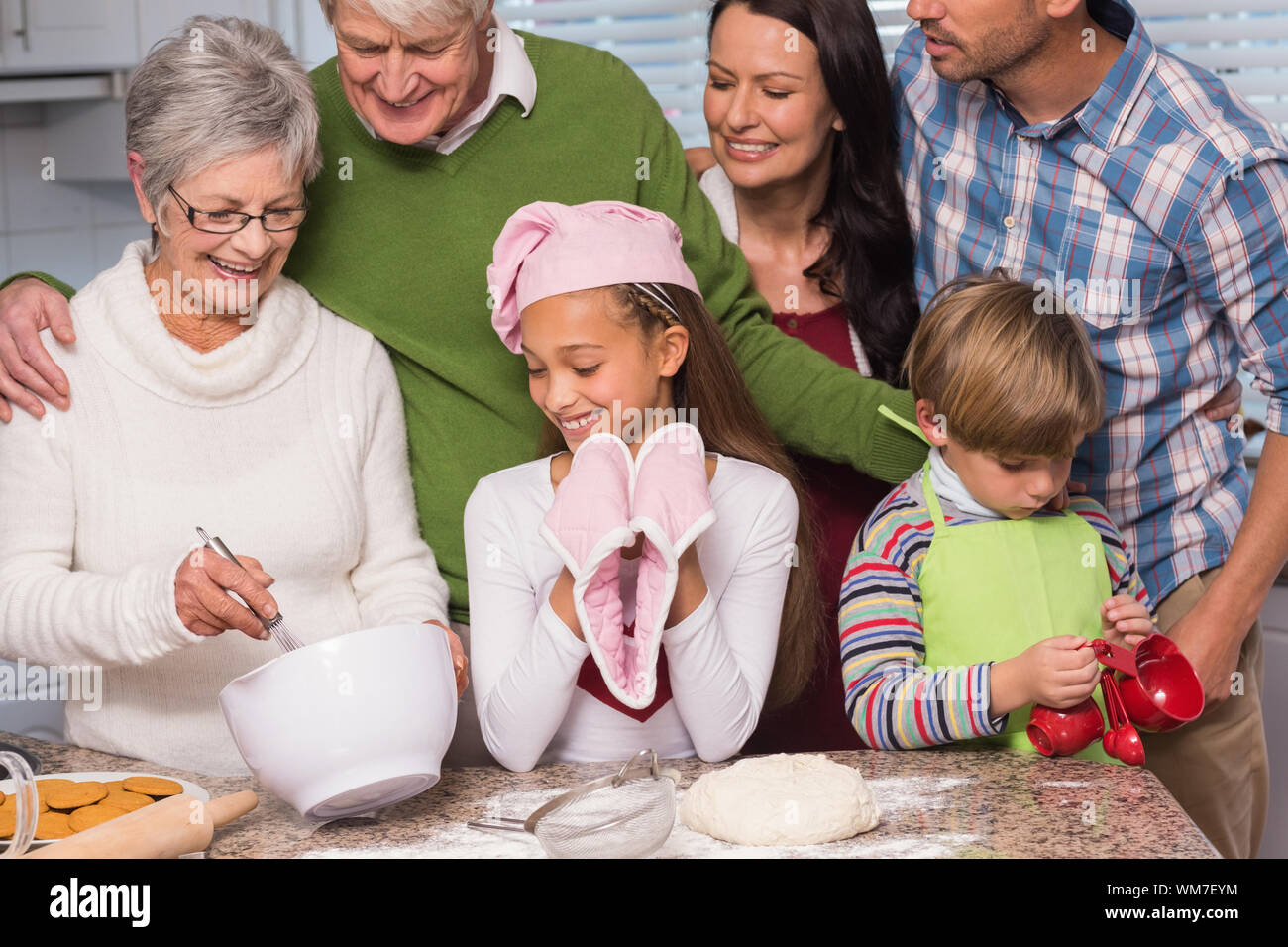 Multi-generation family baking together at home in the kitchen Stock ...