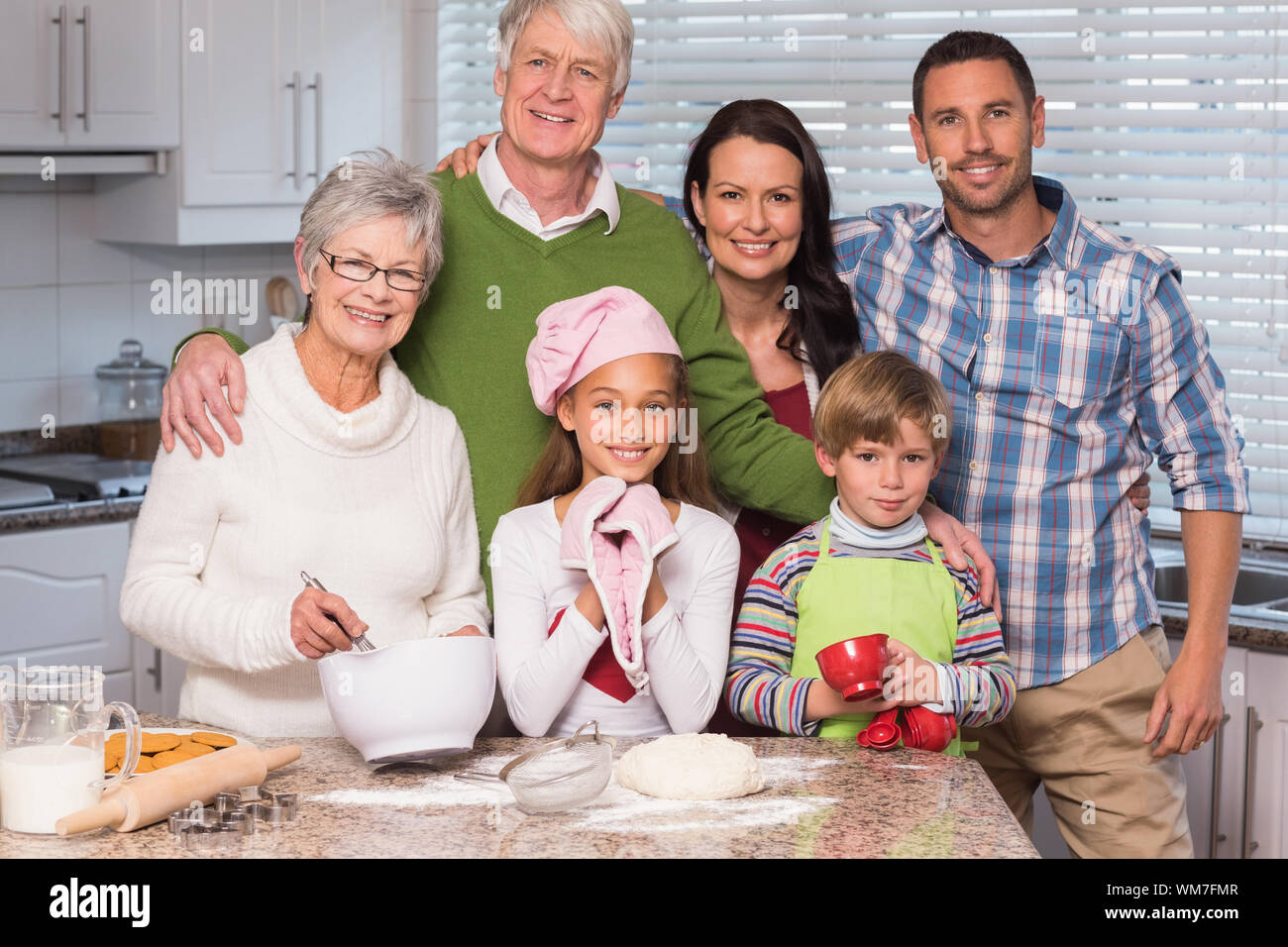 Multi-generation family baking together at home in the kitchen Stock ...