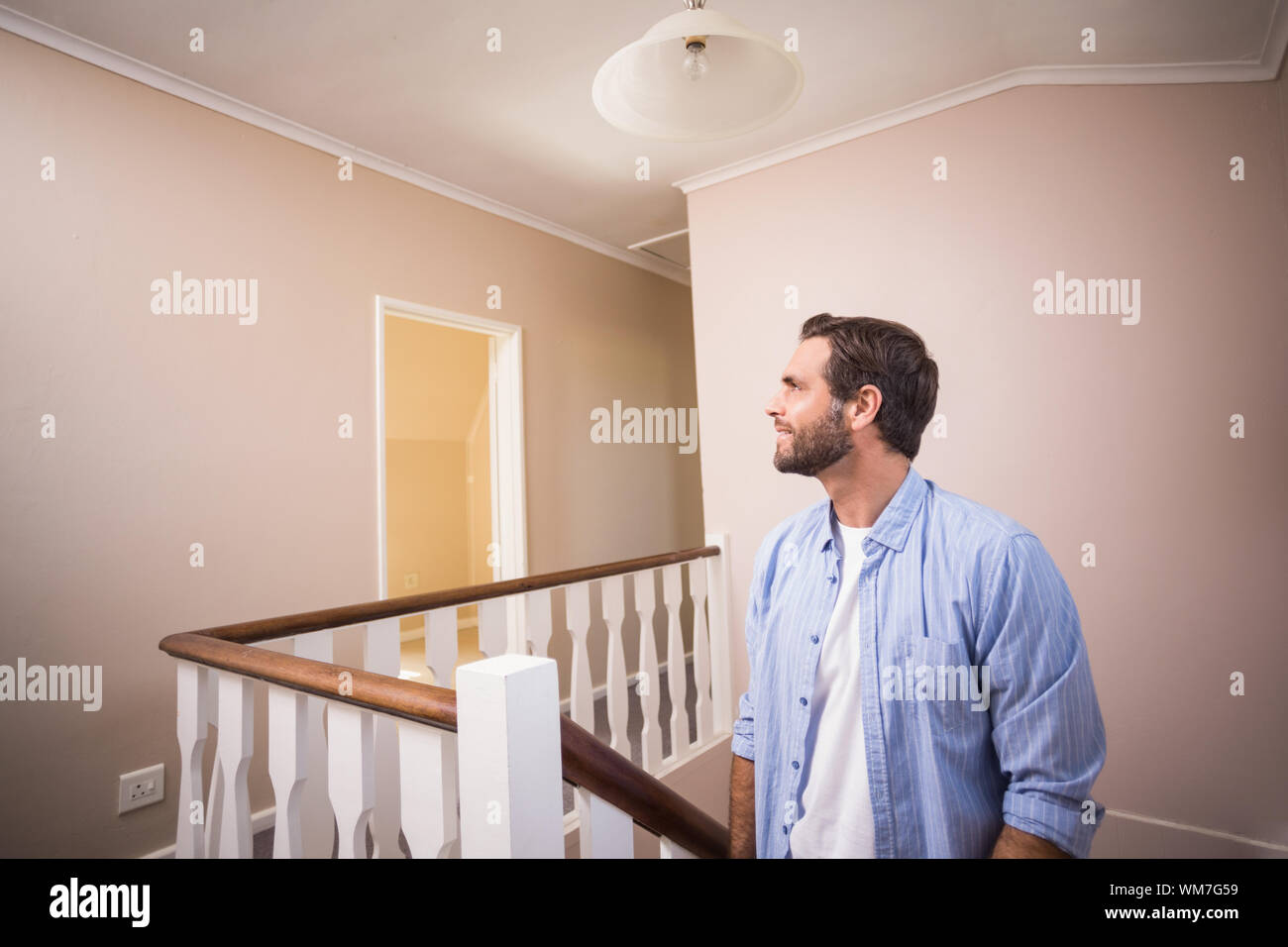 Man walking up apartment stairs hi-res stock photography and images - Alamy