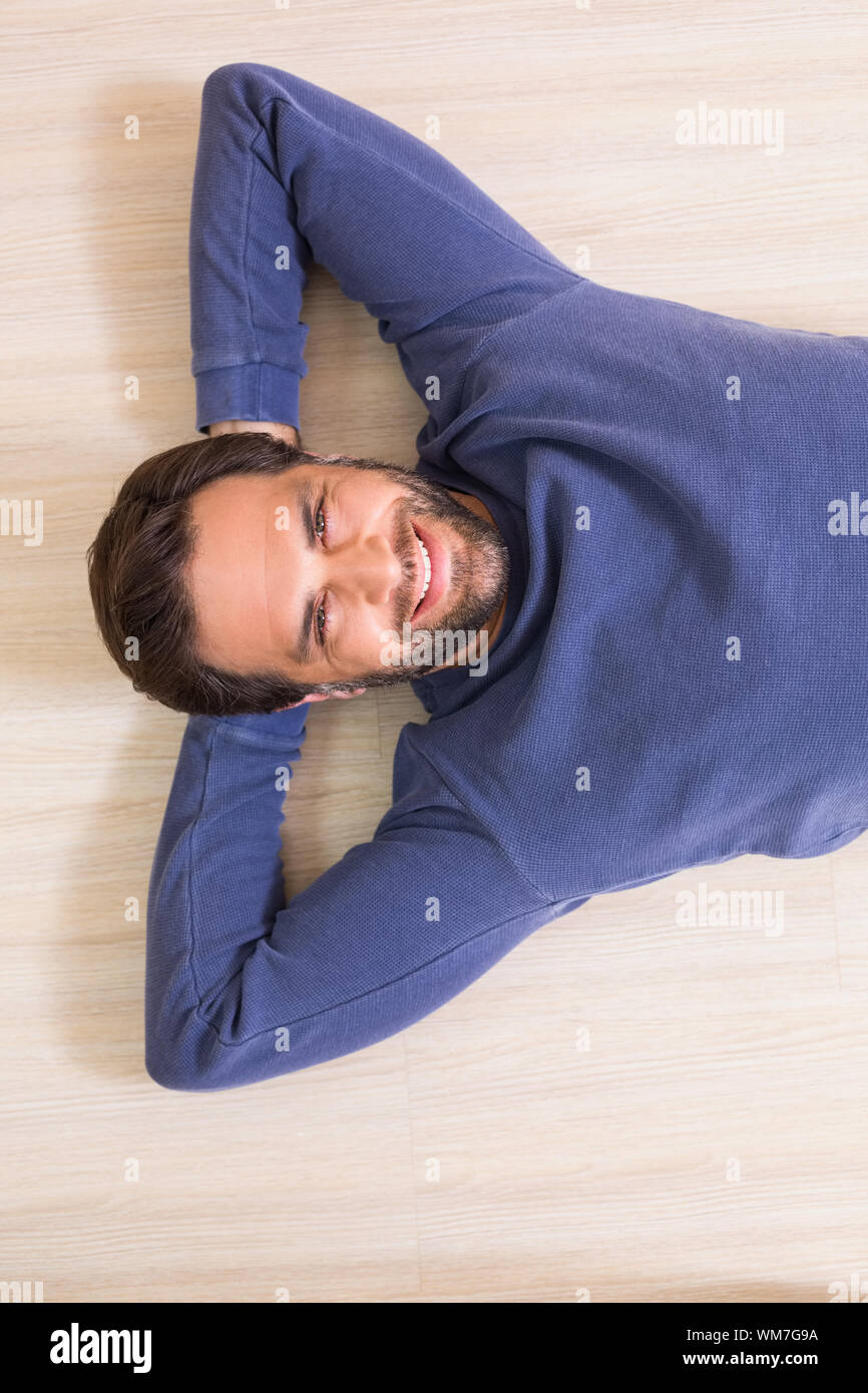 Happy man lying on floor at home in the living room Stock Photo - Alamy