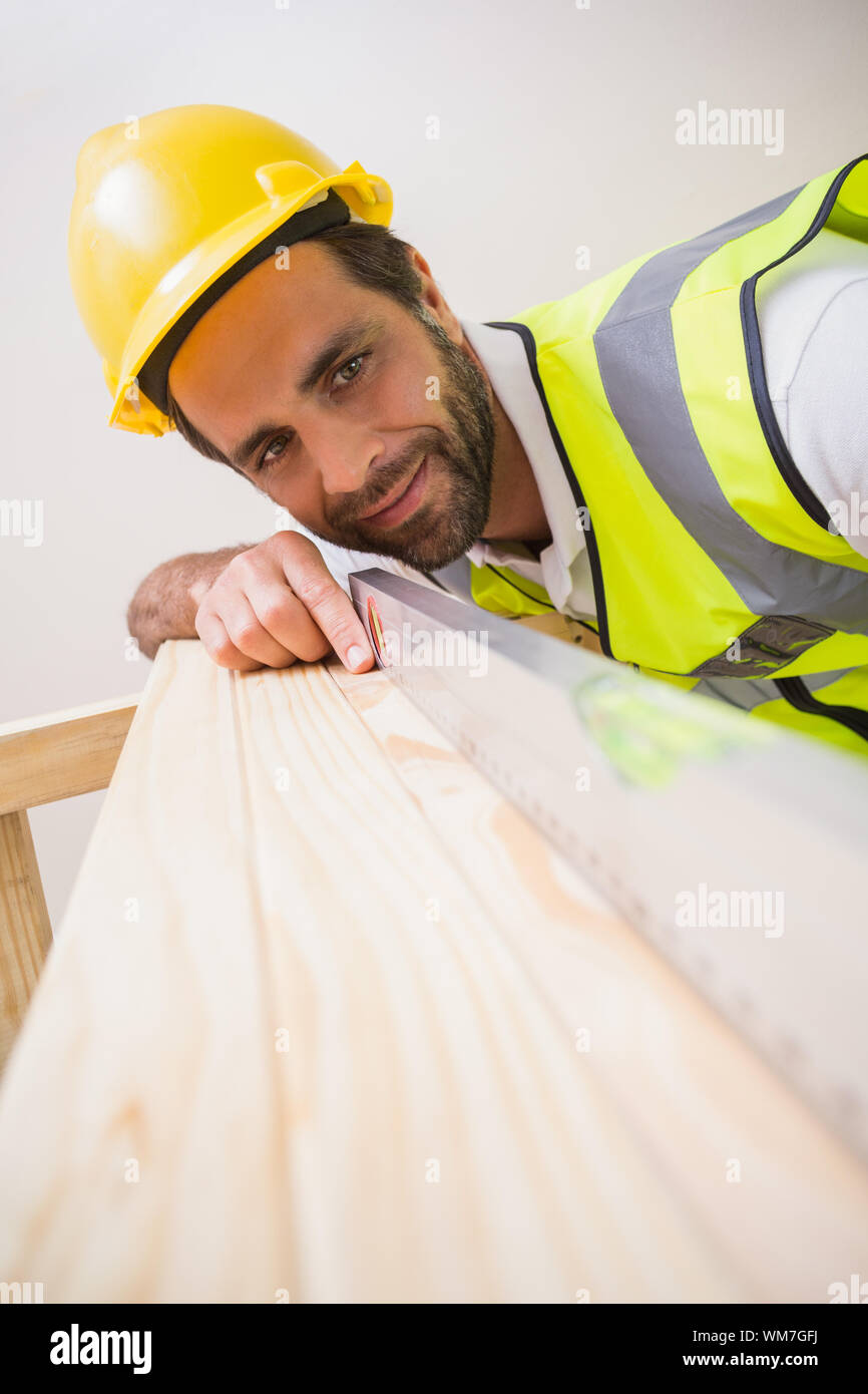 Construction worker using spirit level in a new house Stock Photo - Alamy