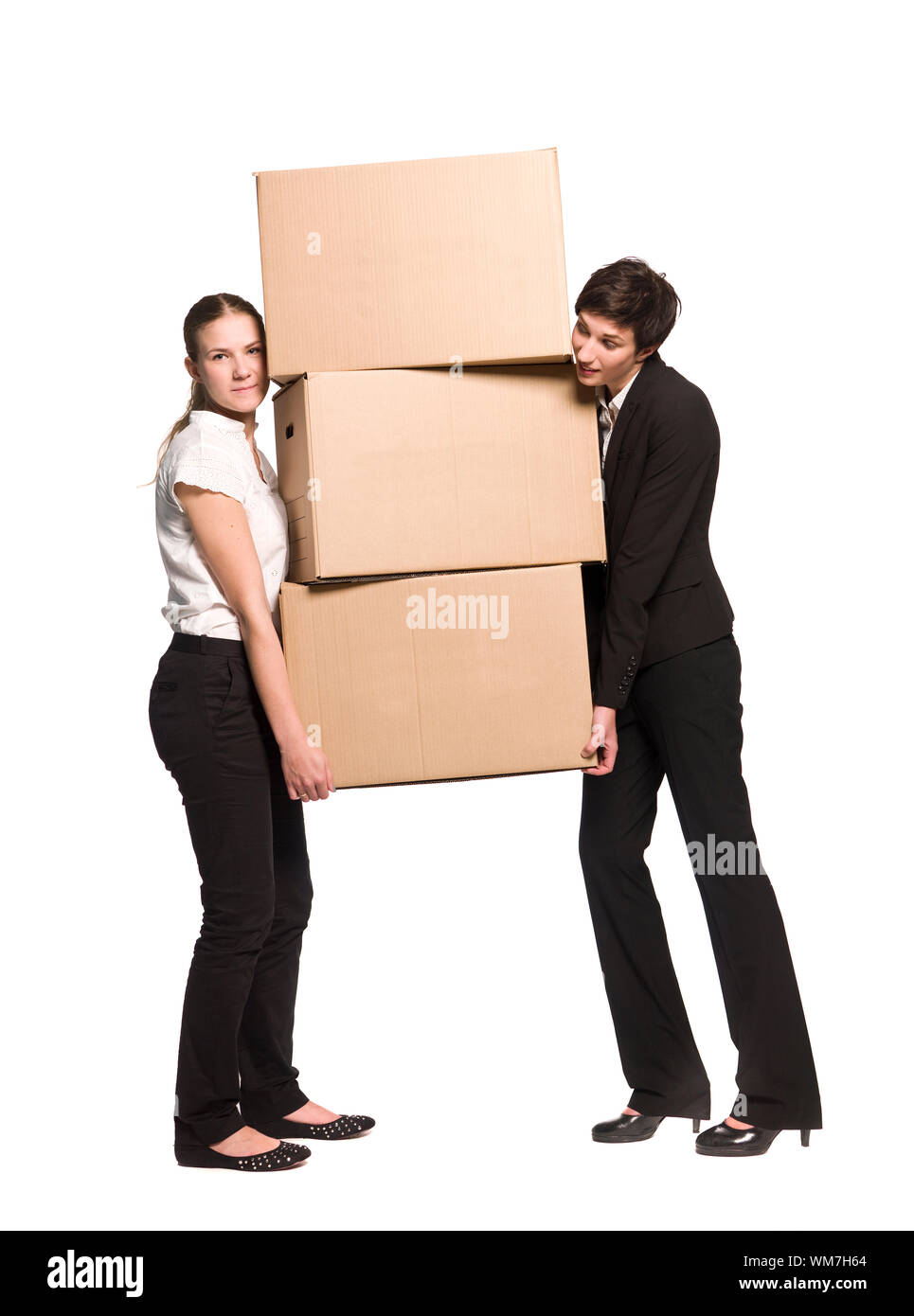 Two women carrying three boxes Stock Photo - Alamy