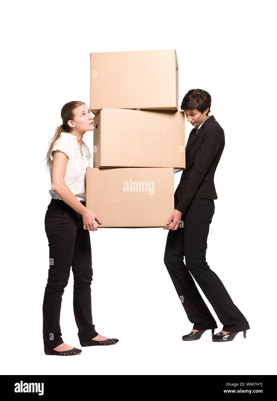 Two women carrying three boxes Stock Photo - Alamy
