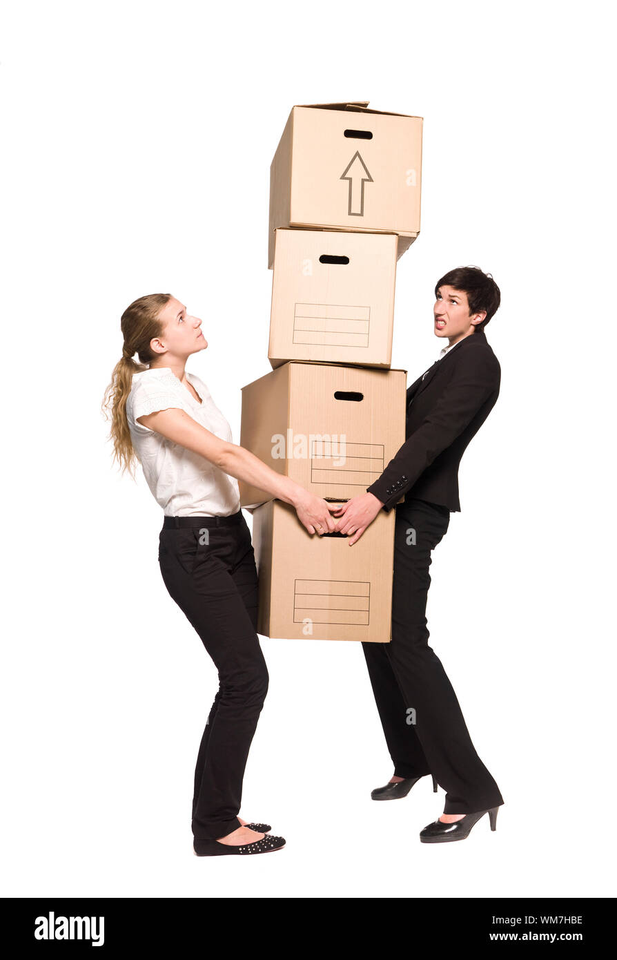 Two women carrying four boxes Stock Photo - Alamy