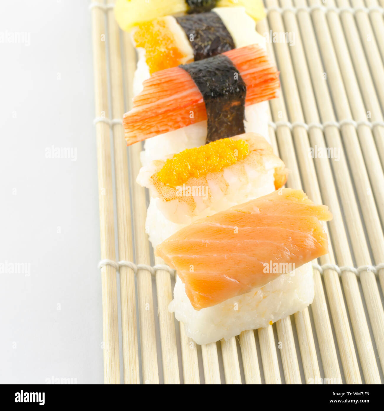 sushi on shusi mat over white background Stock Photo - Alamy