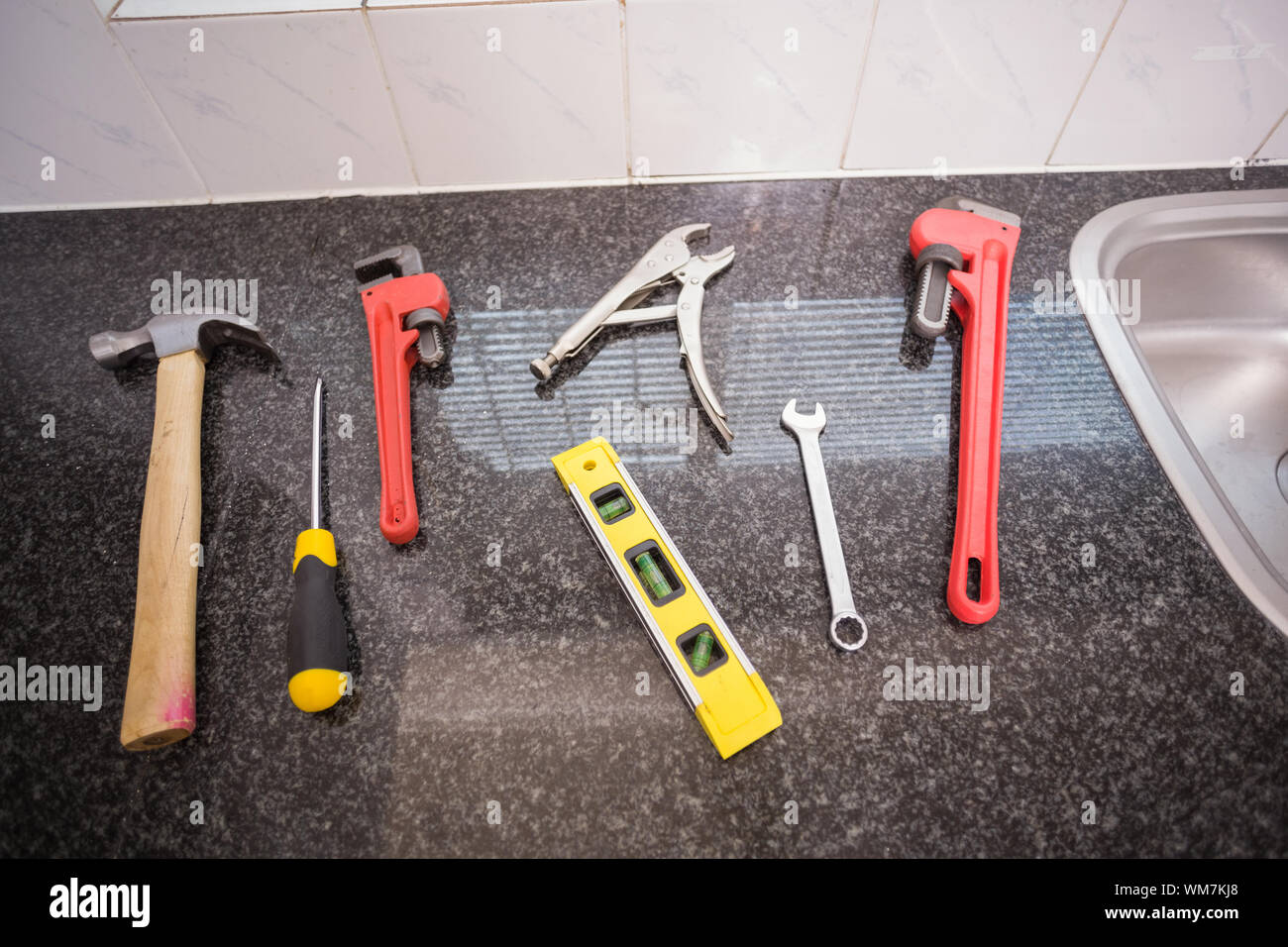 Plumbing tools on the counter in the kitchen Stock Photo - Alamy