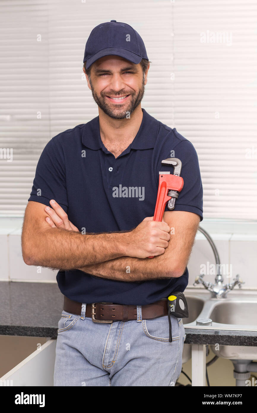 Handsome smiling plumber at the kitchen hi-res stock photography and ...