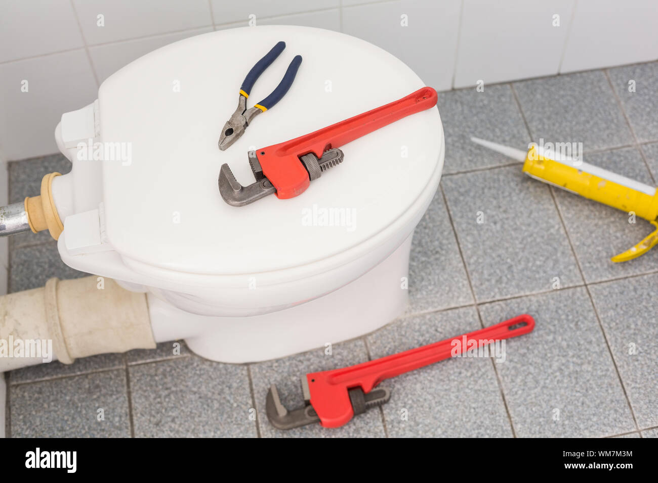 Plumbing tools on the toilet in the bathroom Stock Photo - Alamy