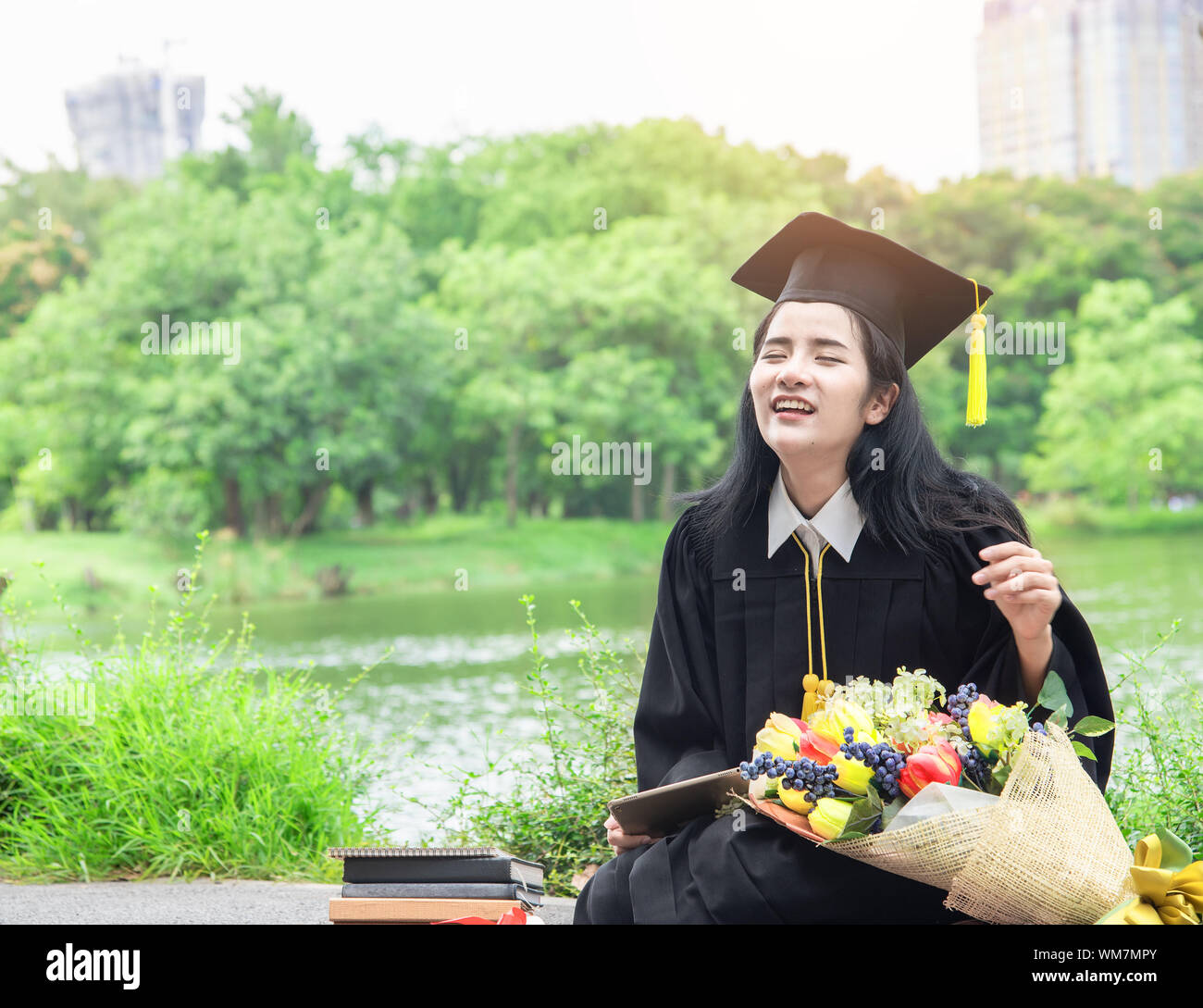 Beautiful asian women graduating holding diploma with pride and smiling ...