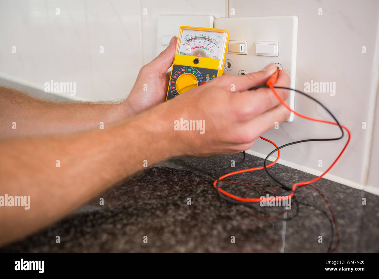 Metering voltage with digital multimeter in the kitchen Stock Photo - Alamy