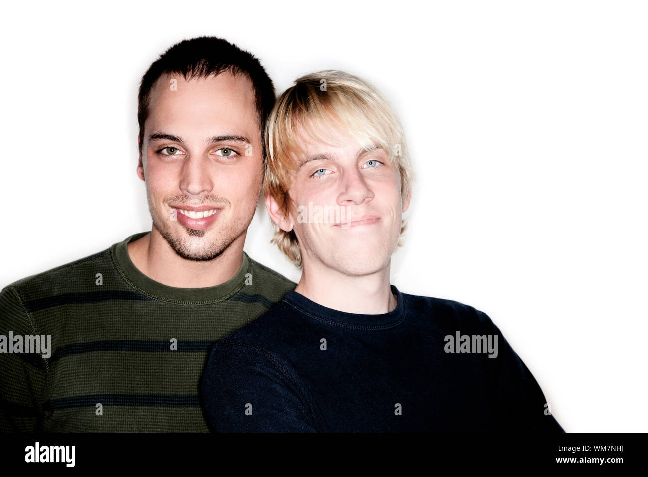 Two handsome men posing for portrait on white background Stock Photo ...