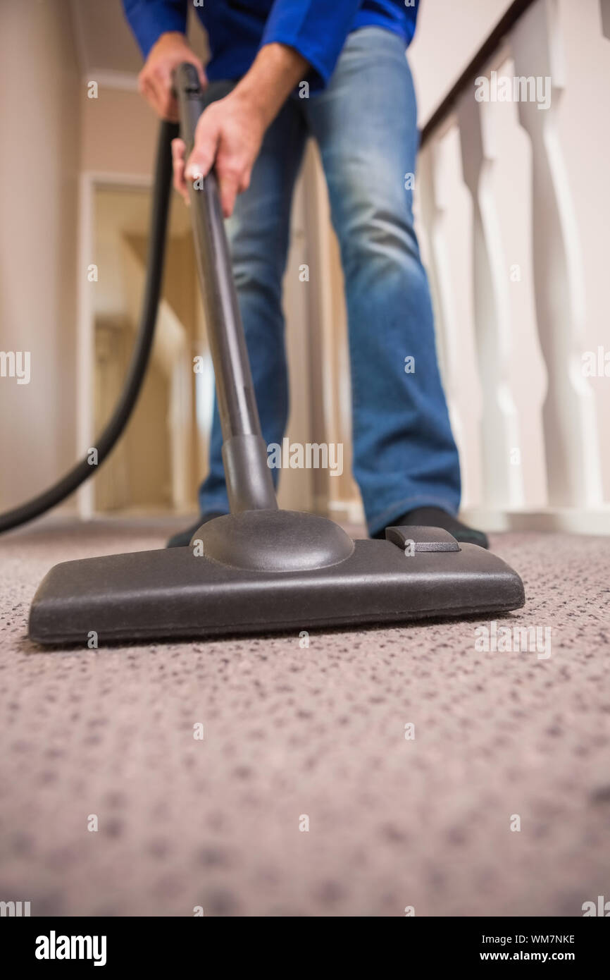 Close up a young man vacuuming at home Stock Photo - Alamy