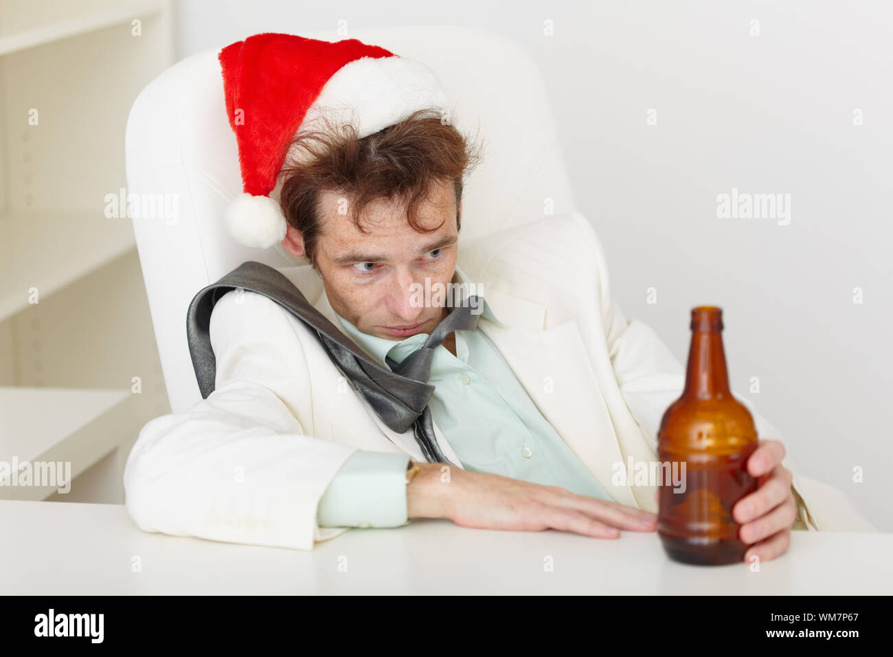 Man sits at a table and suffers from a hang-over Stock Photo - Alamy