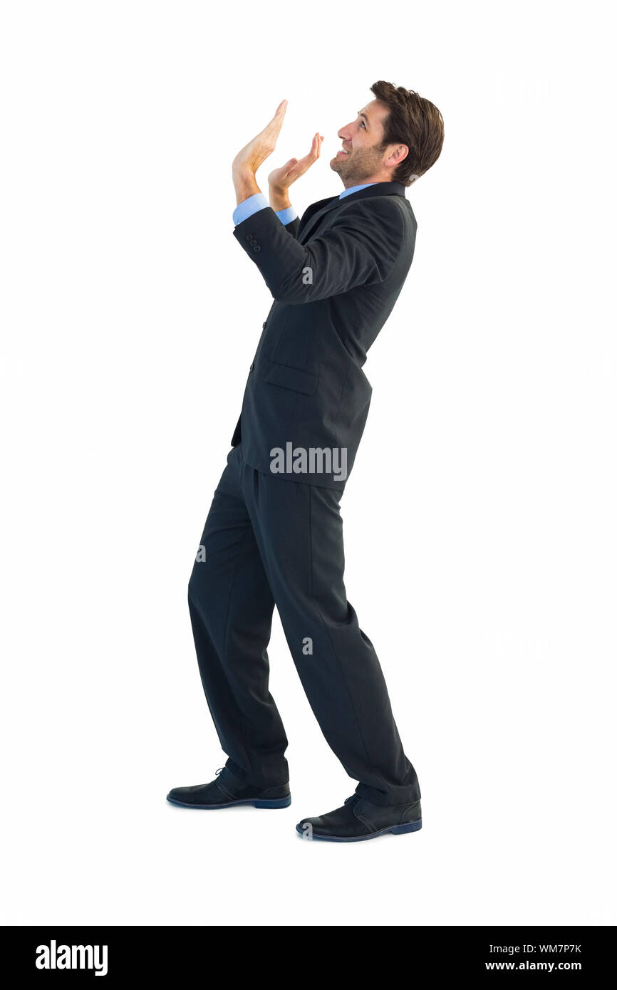 Focused businessman pushing with hands on white background Stock Photo ...