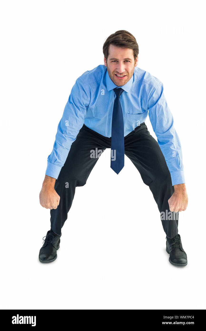 Focused businessman lifting up something heavy on white background ...