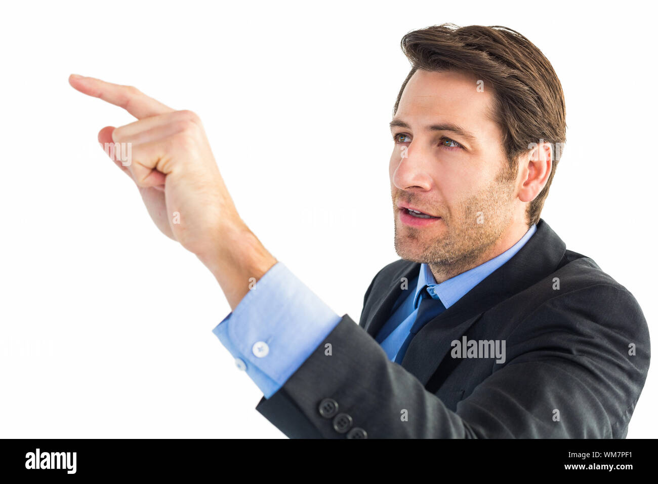 Serious businessman pointing at something on white background Stock ...