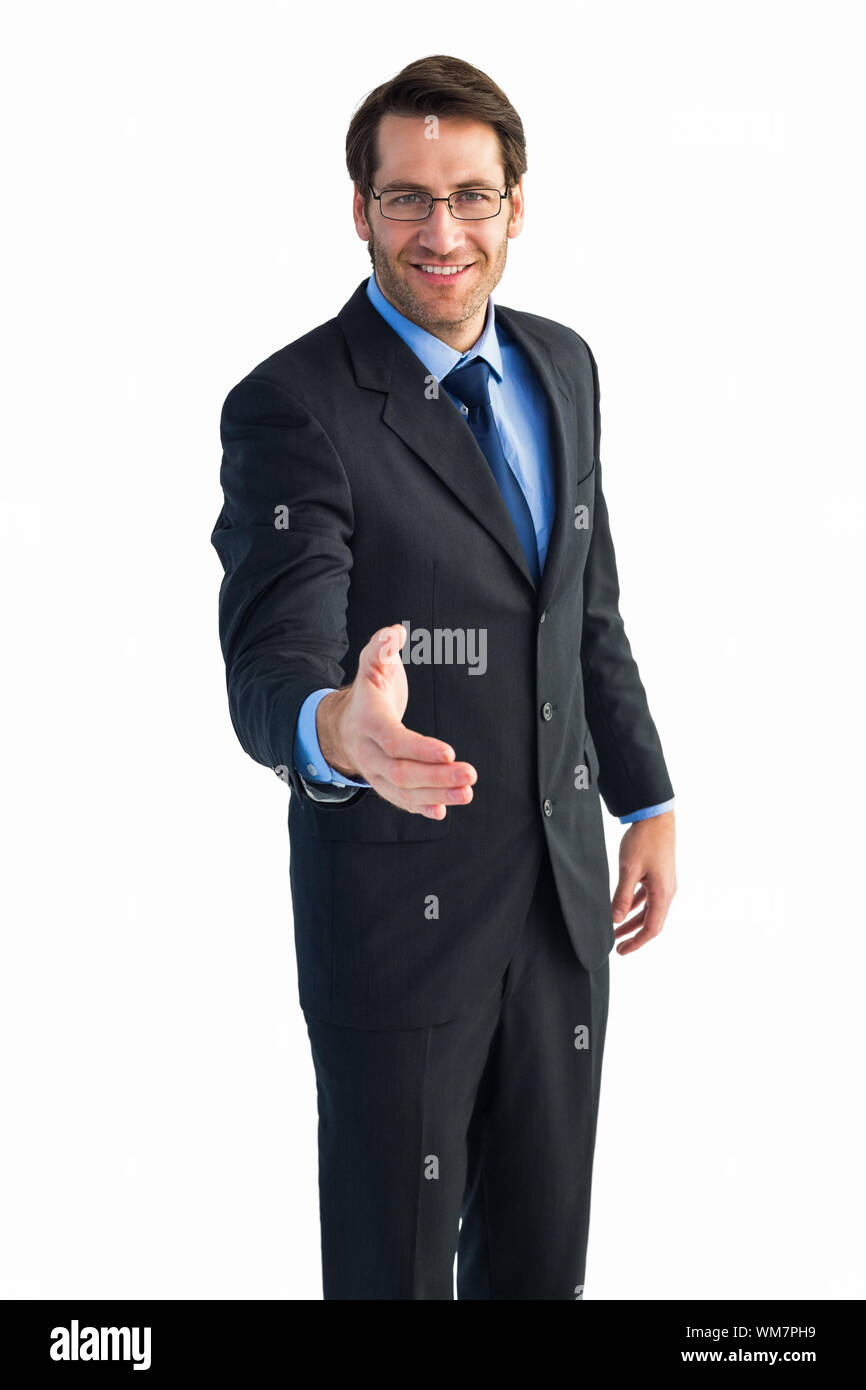 Hand being offered by smiling businessman on white background Stock ...