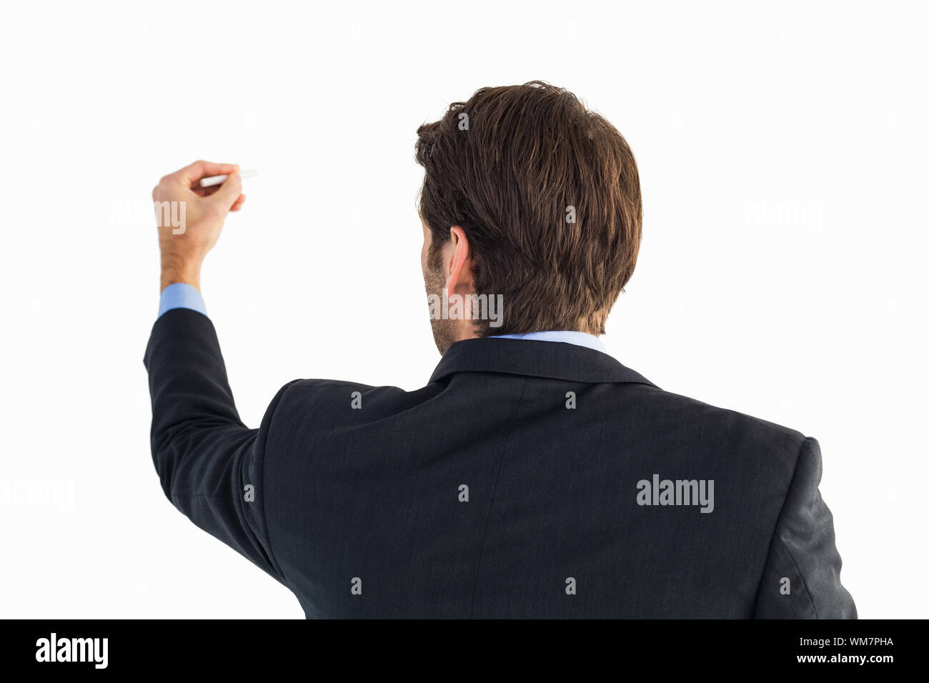 Rear view of businessman writing with a white chalk on white background ...