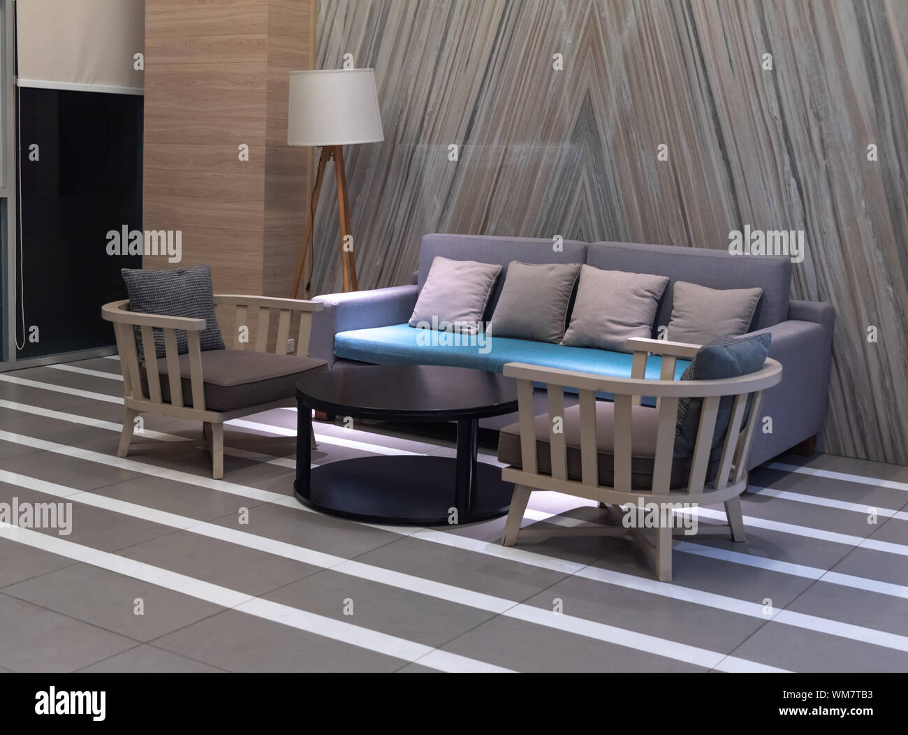 Modern living room design with pillows on cozy sofa and wooden lamps ...