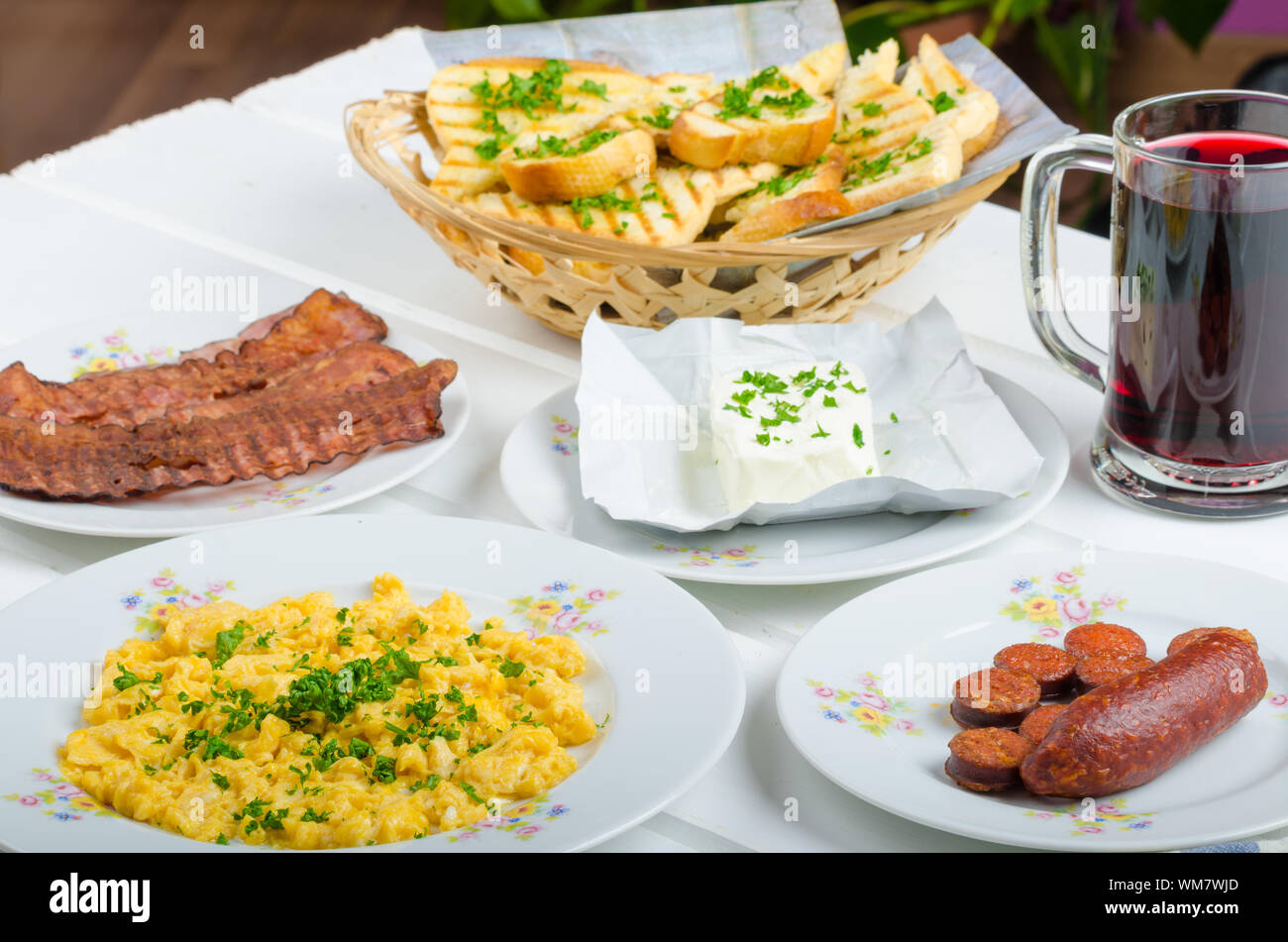 A hearty breakfast of eggs, bacon, sausage and toasted baguette and ...