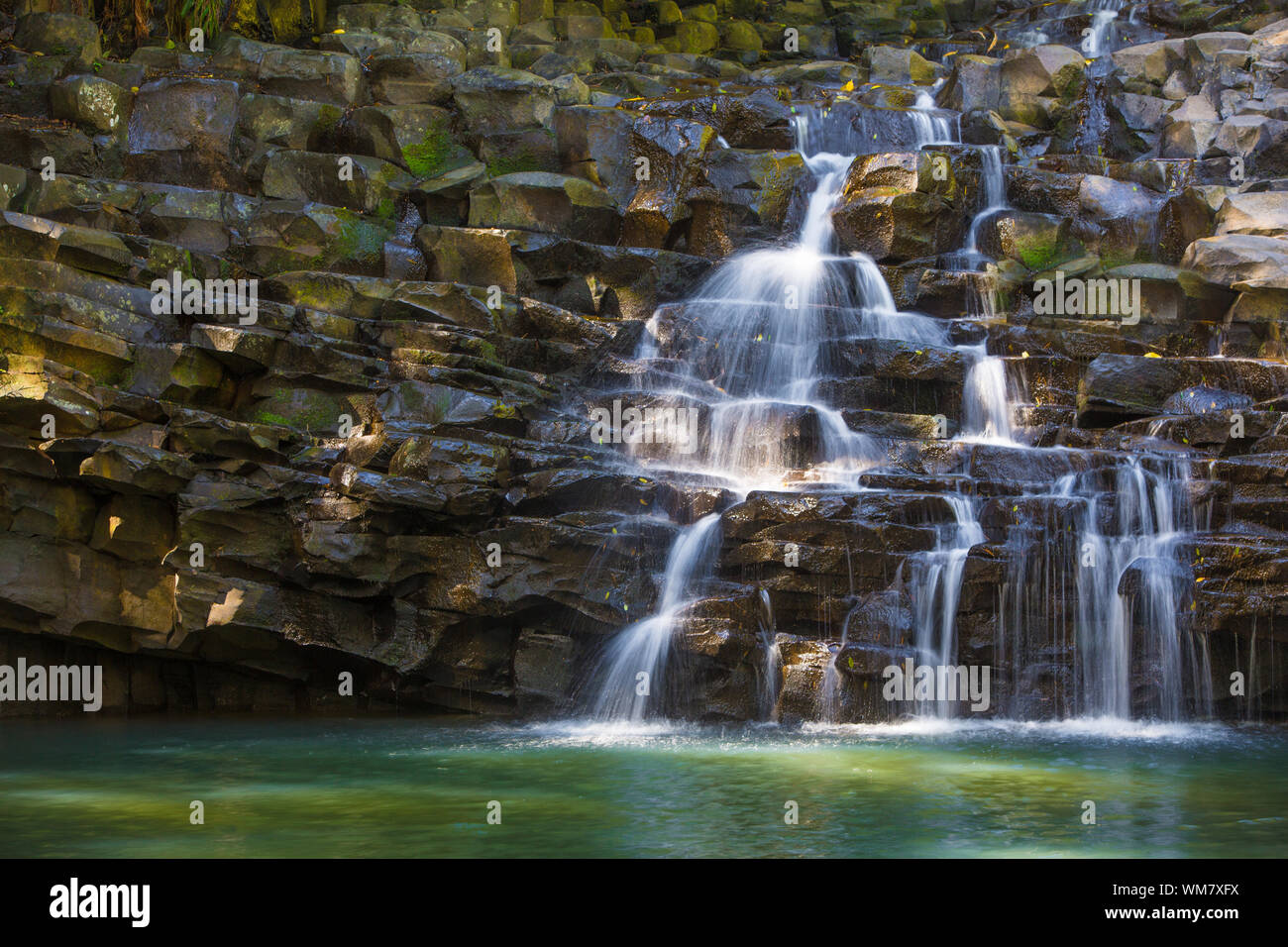 Water falling over rocks into pond in Maui Hawaii Stock Photo - Alamy