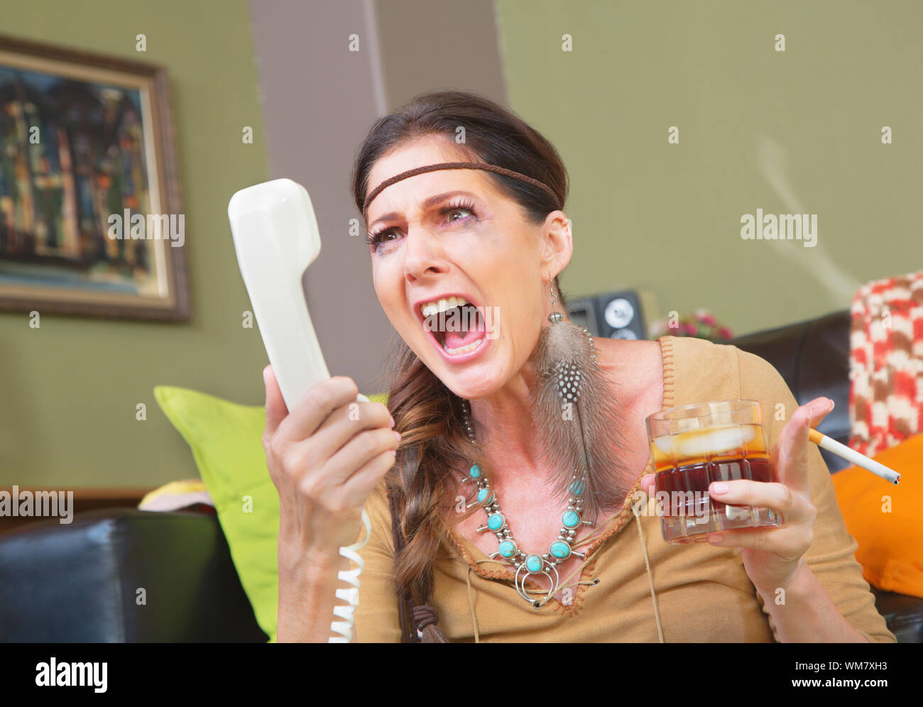 Angry smoker with drink yelling into telephone Stock Photo - Alamy
